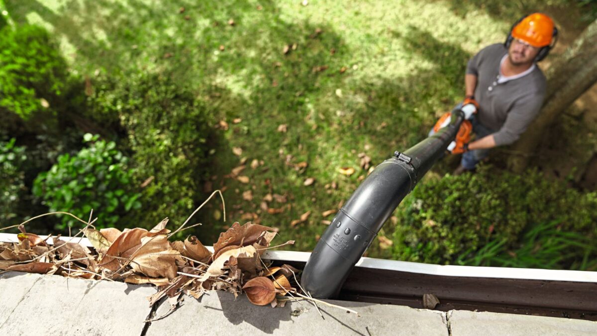 Clearing your gutters with a leaf blower